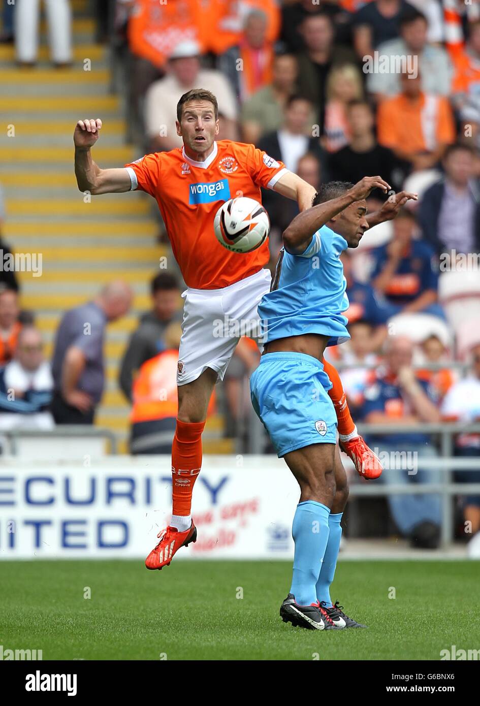 Blackpool's Kirk Broadfoot (left) and Barnsley's Chris O'Grady (right ...