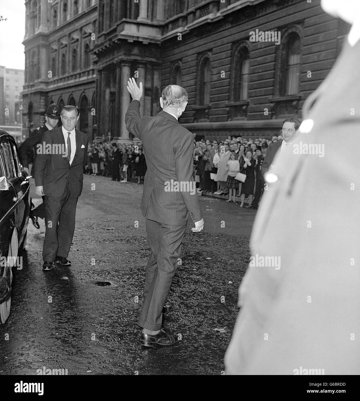 Lord Home turns to wave to the cheering crowd as he returns to No 10 Downing Street from ...