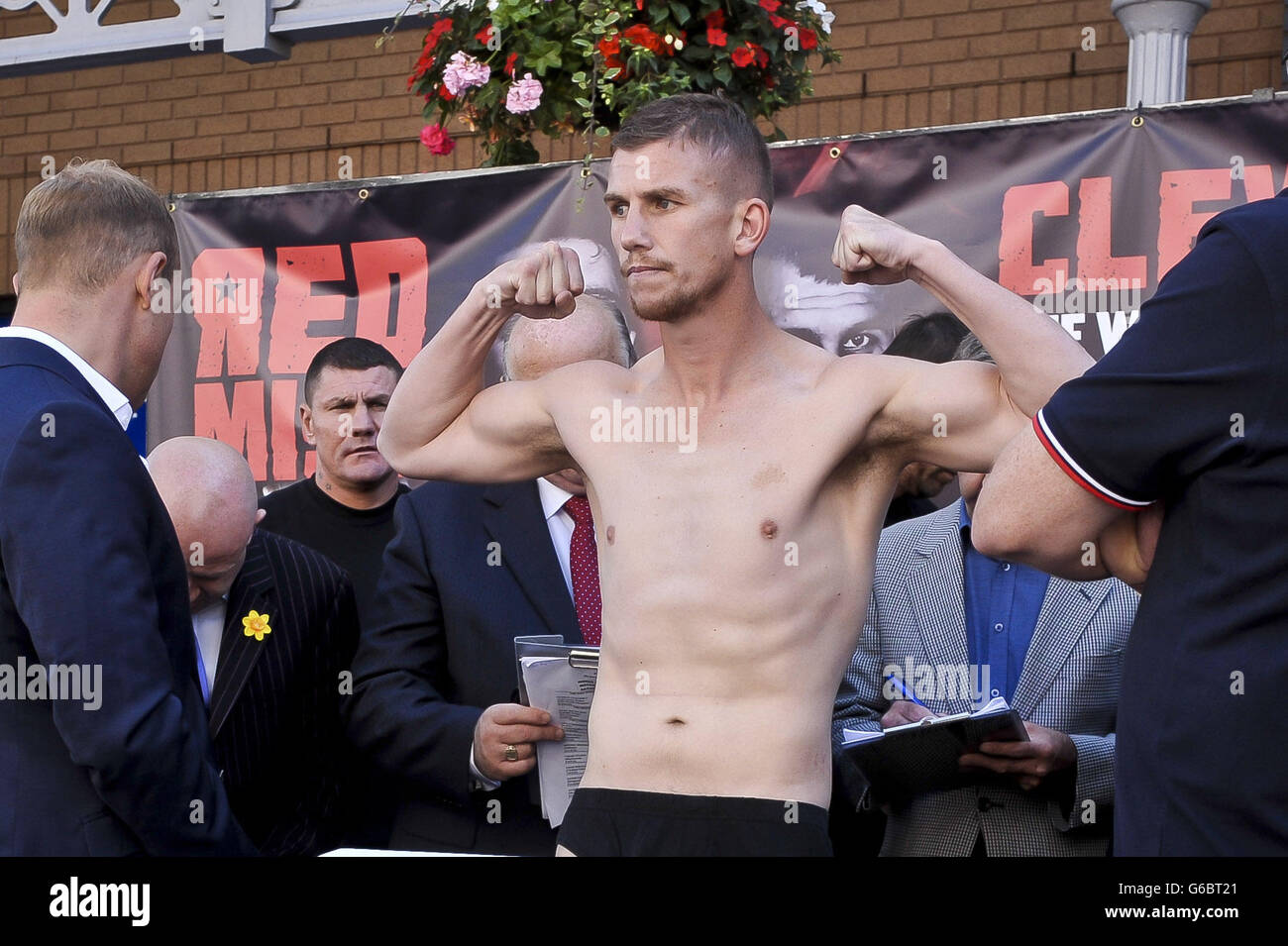 Gary Buckland flexes his muscles during the weigh in in Queen Street ...