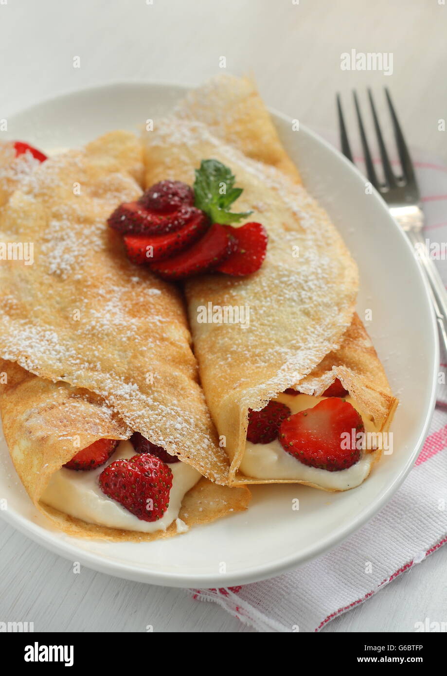 Crepes with strawberry jam and cream Stock Photo - Alamy