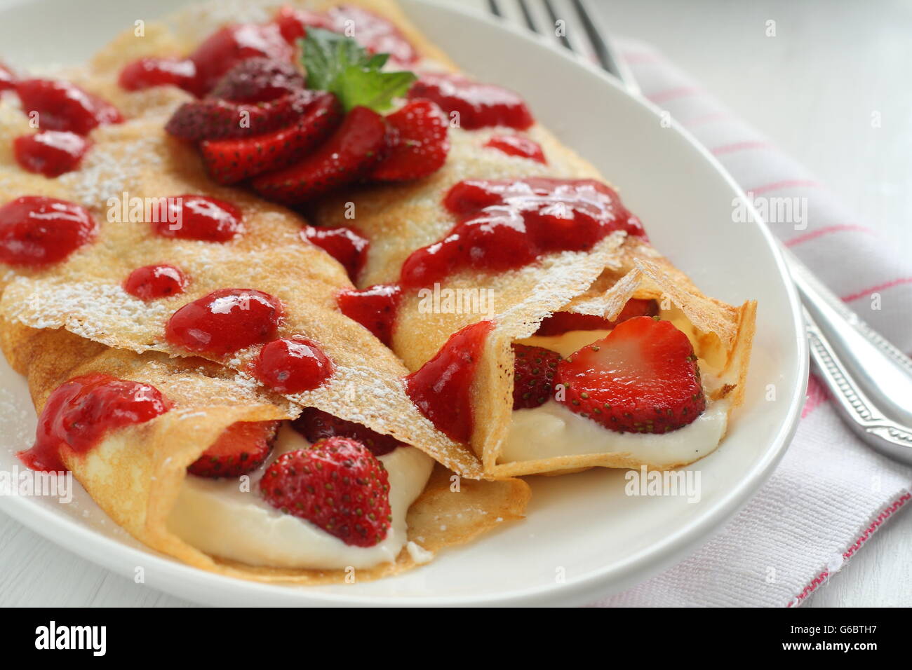 Crepes with strawberry jam and cream Stock Photo - Alamy