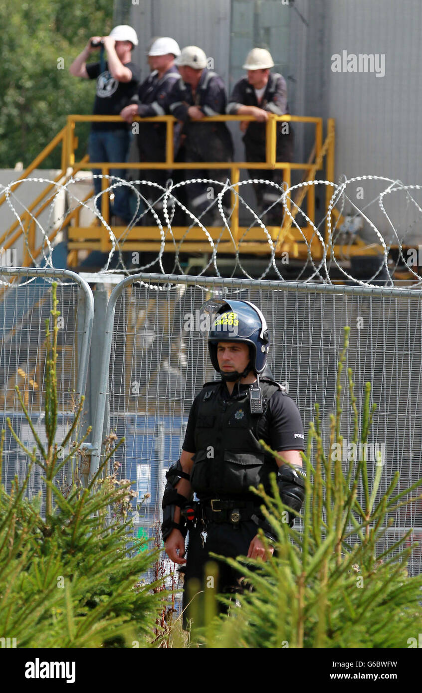 A police officer stands at the perimeter fence of the Cuadrilla ...