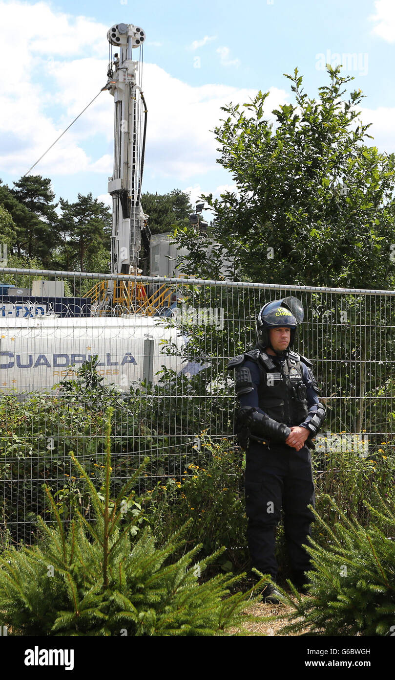 A police officer stands at the perimeter fence of the Cuadrilla ...