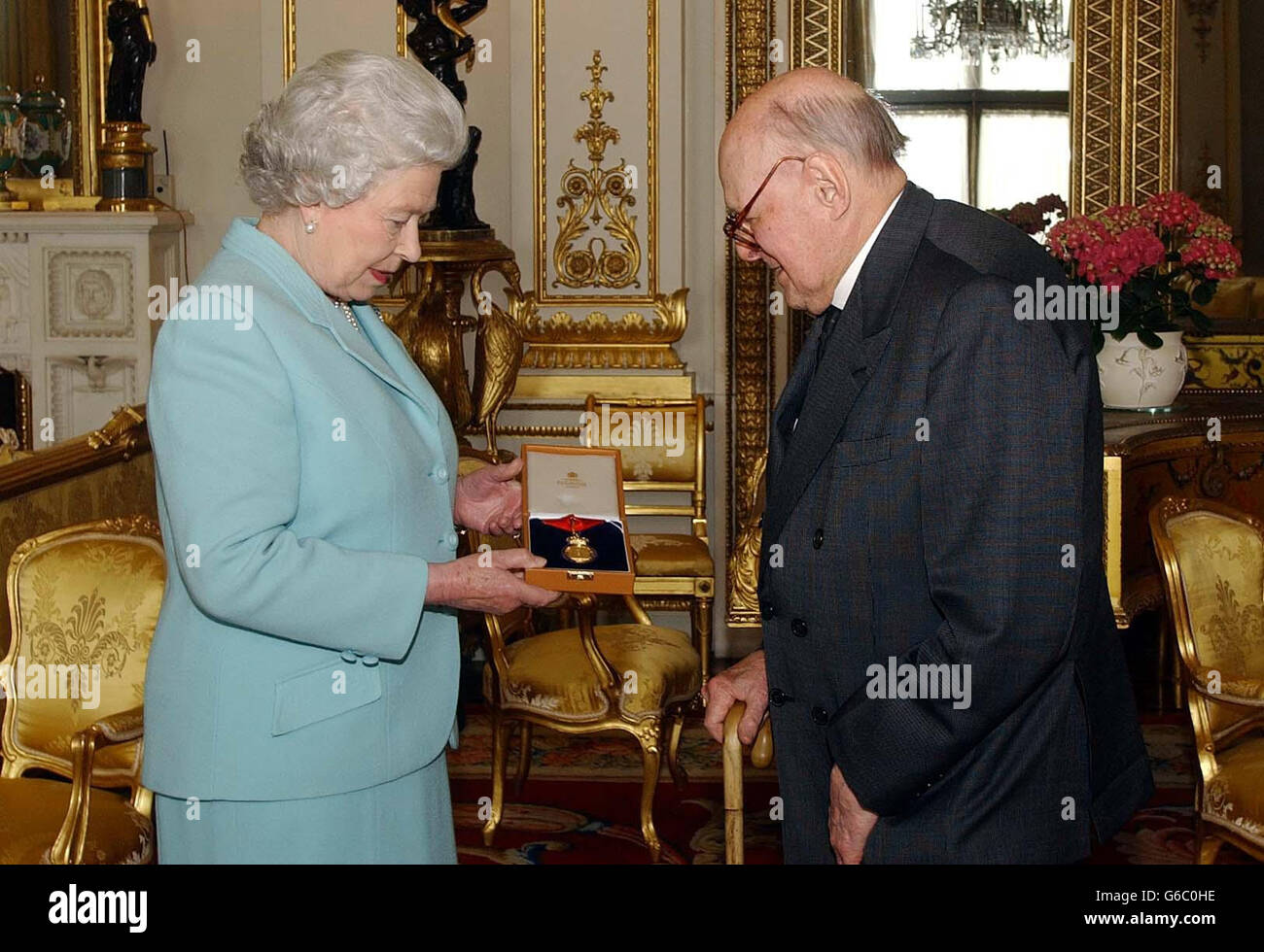 Queen Elizabeth II confers Sir Denis Mahon with the Insignia of ...