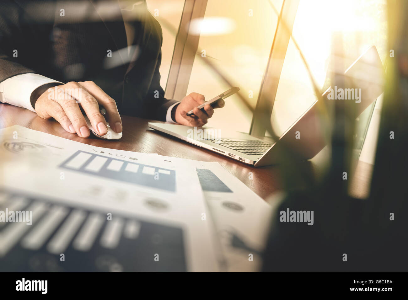 business documents on office table with smart phone and laptop computer ...