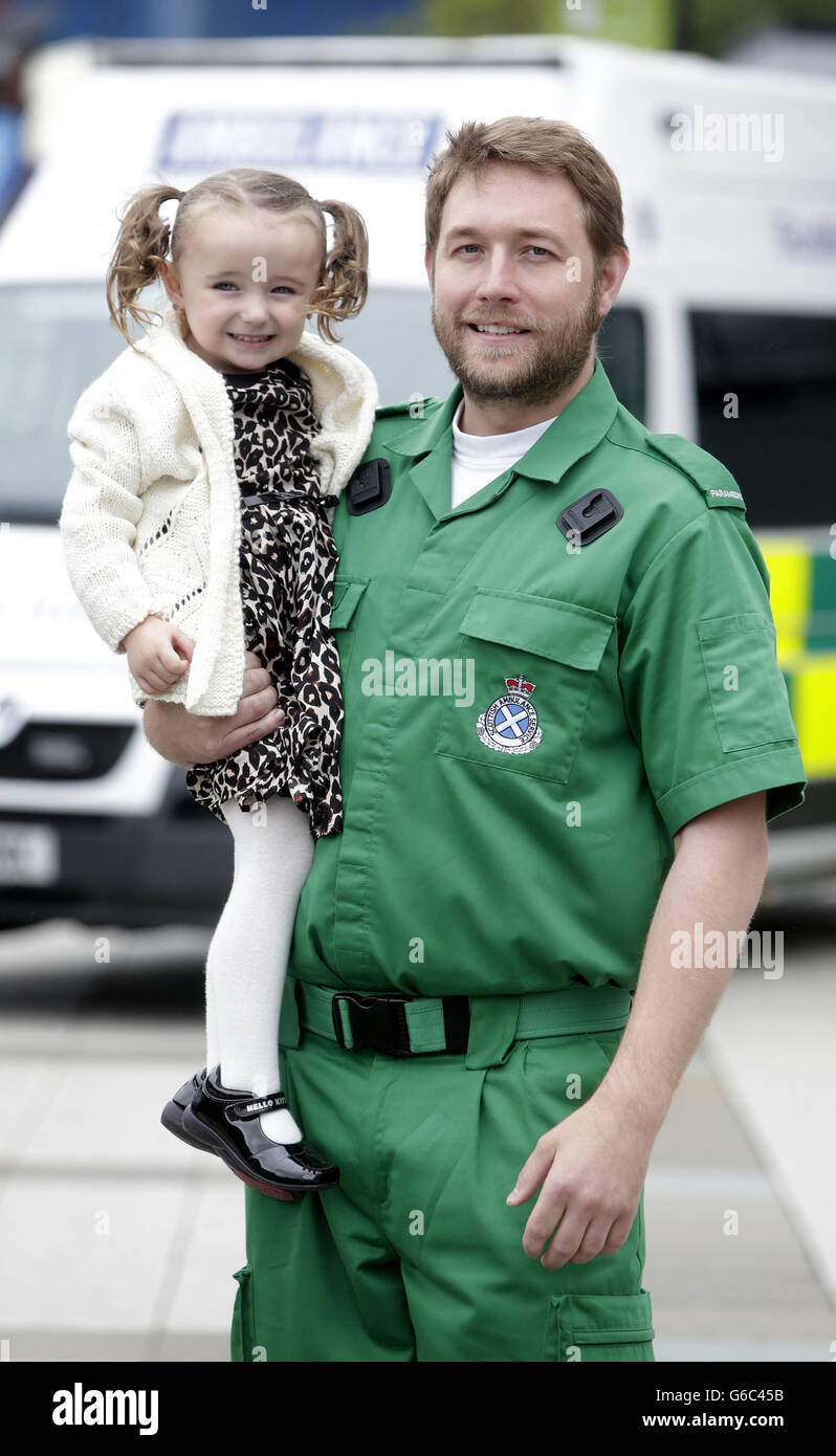 Three-year-old Casey McLean with paramedics Andy Houston one of the ...