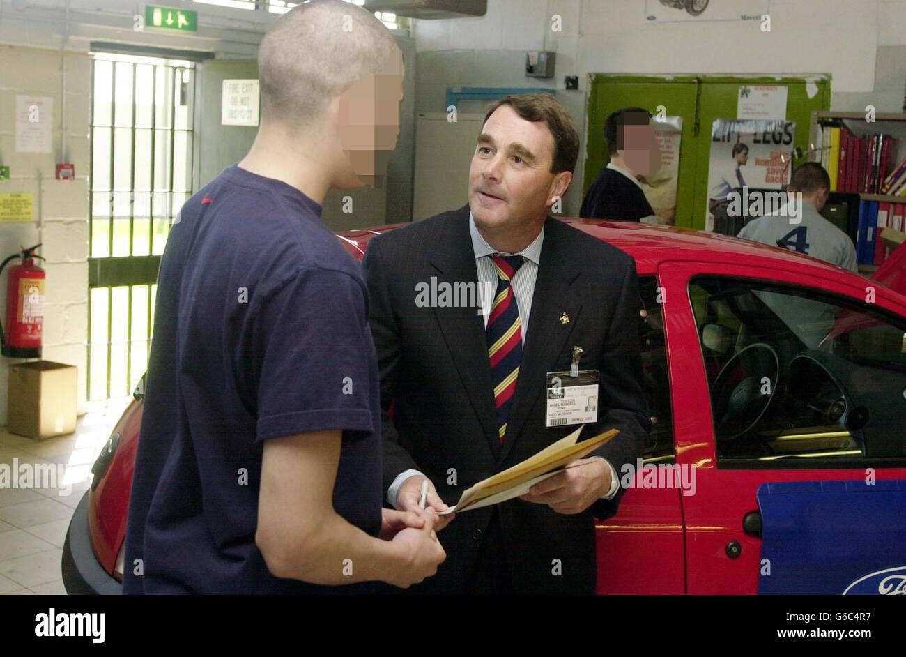 Former Formula 1 racing driver Nigel Mansell talks to a young offender ...