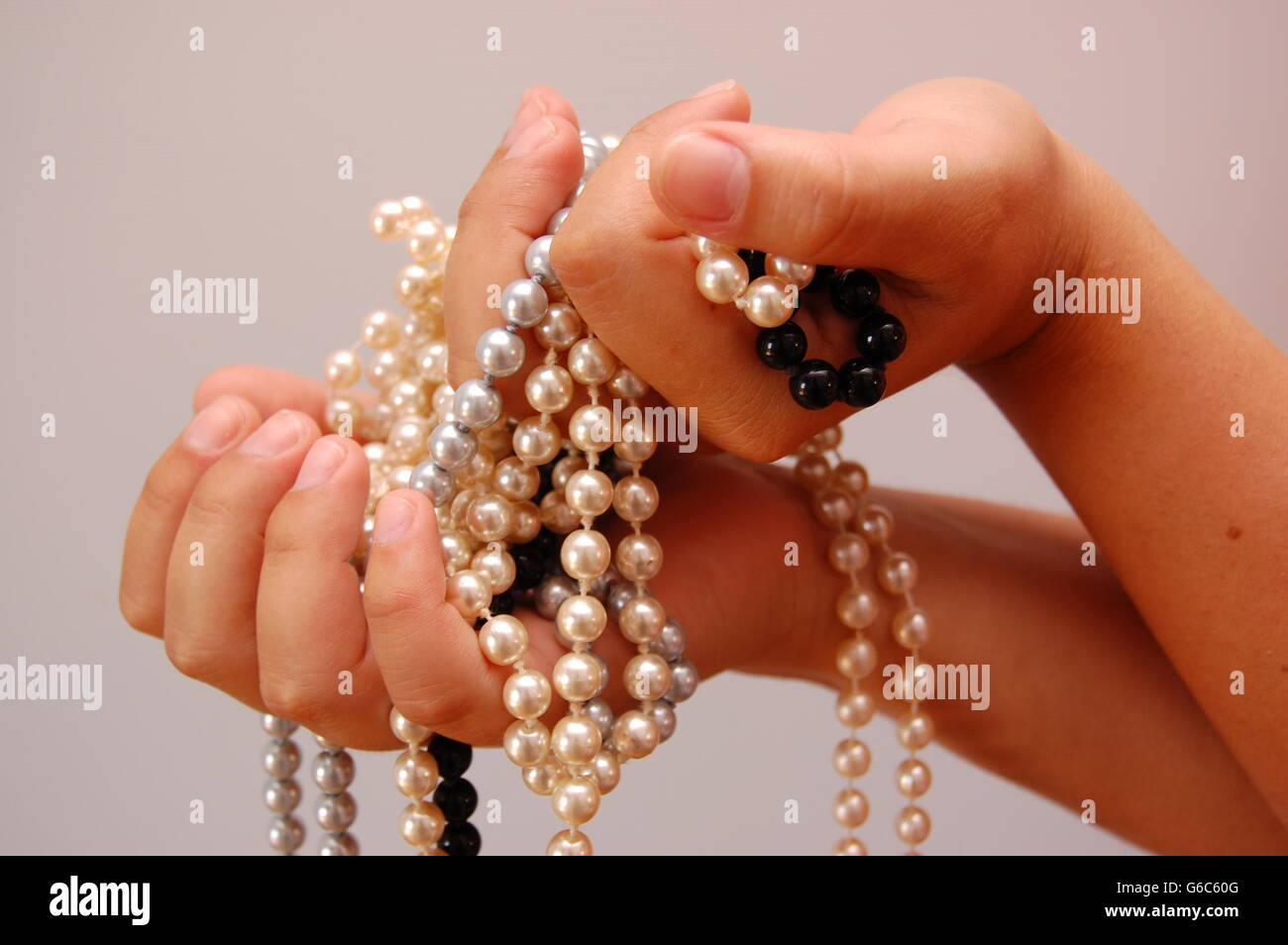 Hands holding pearls necklace Stock Photo - Alamy