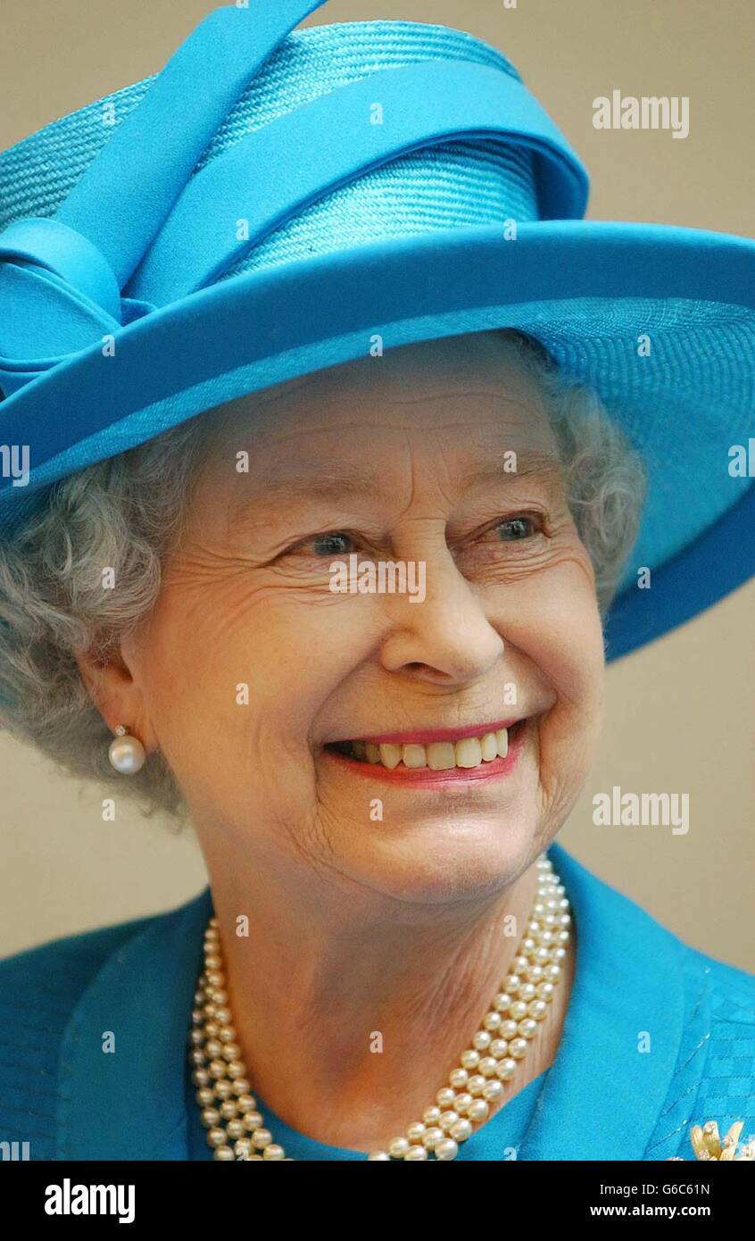 Queen Elizabeth II smiles at waving students while touring the new ...