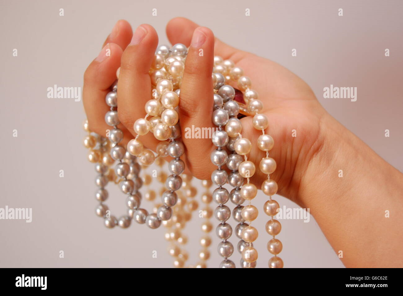 Hands holding pearls necklace Stock Photo - Alamy