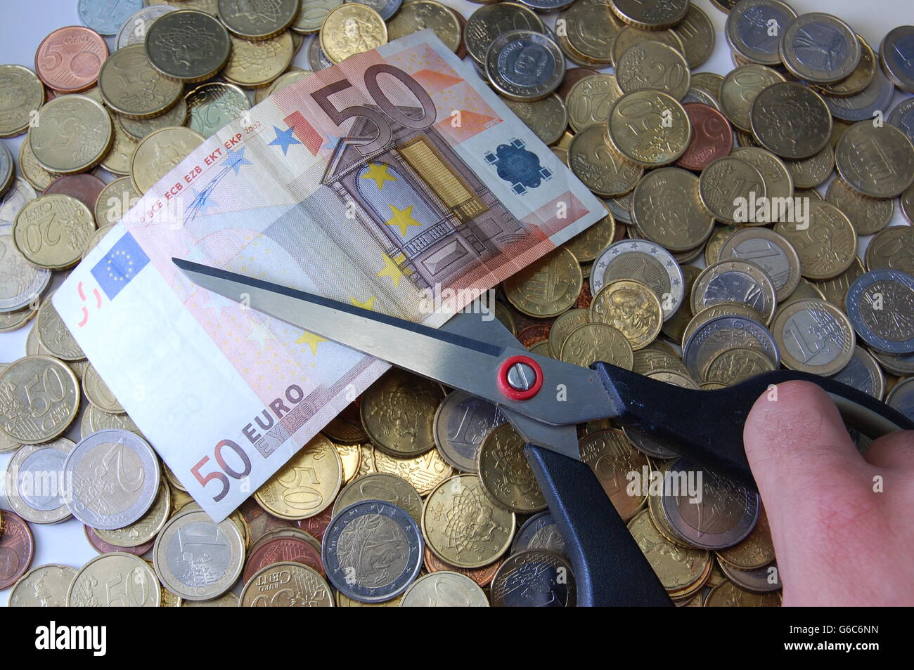 Cutting coins hi-res stock photography and images - Alamy