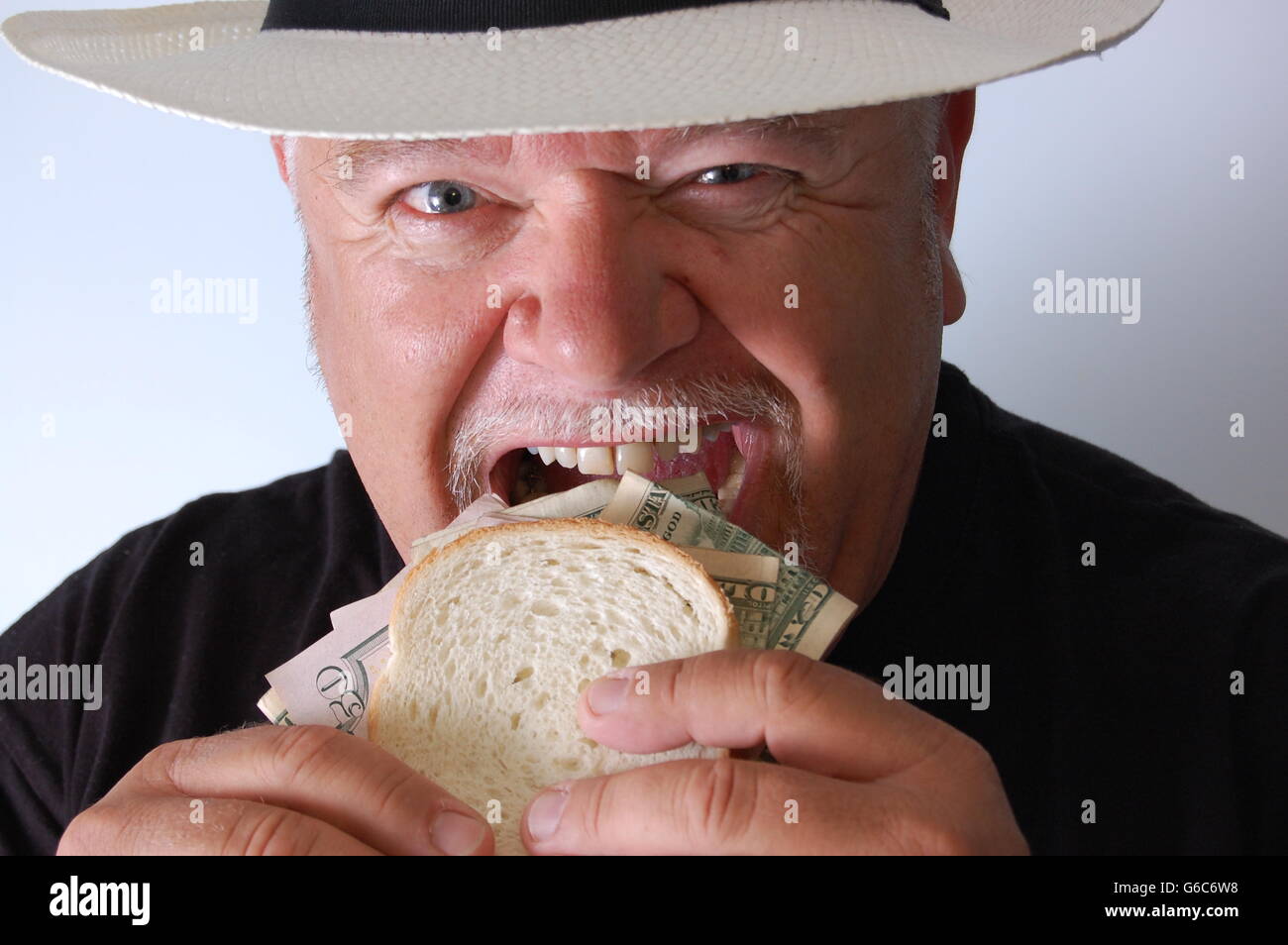 A mean eating money in a sandwich Stock Photo - Alamy
