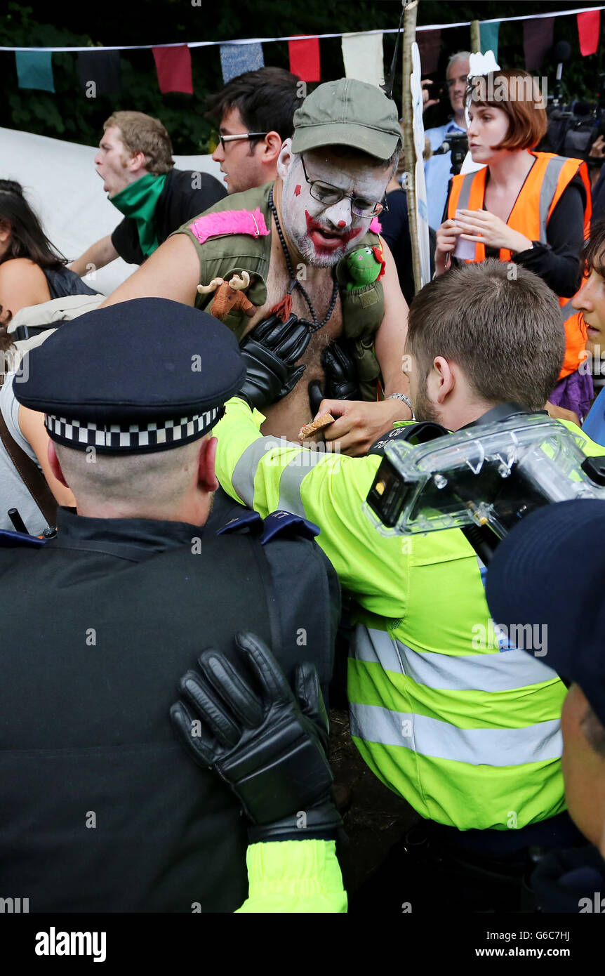 Police officers push back protestors to clear the road outside the main ...