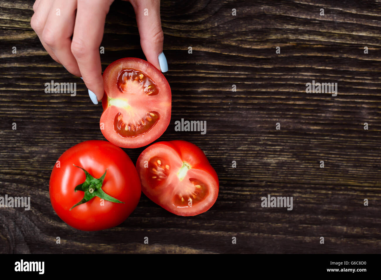 The girl in the hands holding a tomato Stock Photo - Alamy