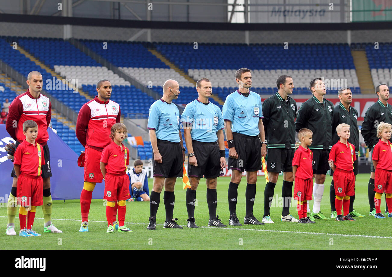 The officials line up alongside both teams before the game Stock Photo ...