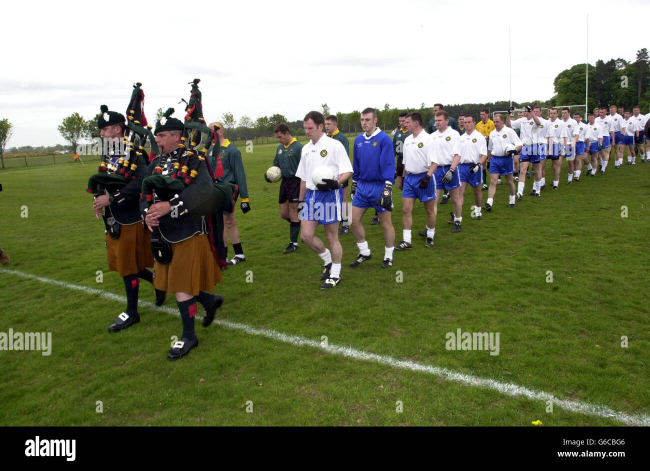 Irish Army and British Army teams are led out on to the pitch at the ...