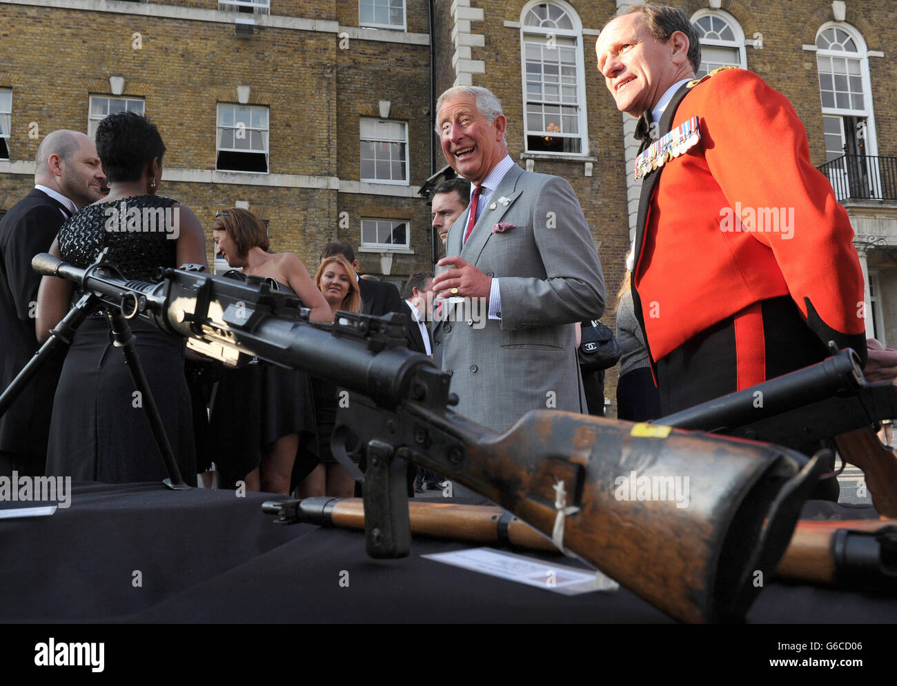 The Prince of Wales looks at a display of weapons with Lieutenant ...