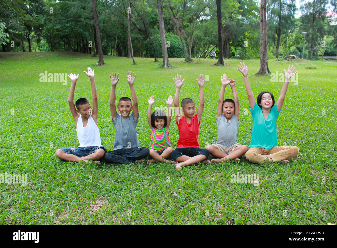 Six children playing in the park, spring time Stock Photo - Alamy