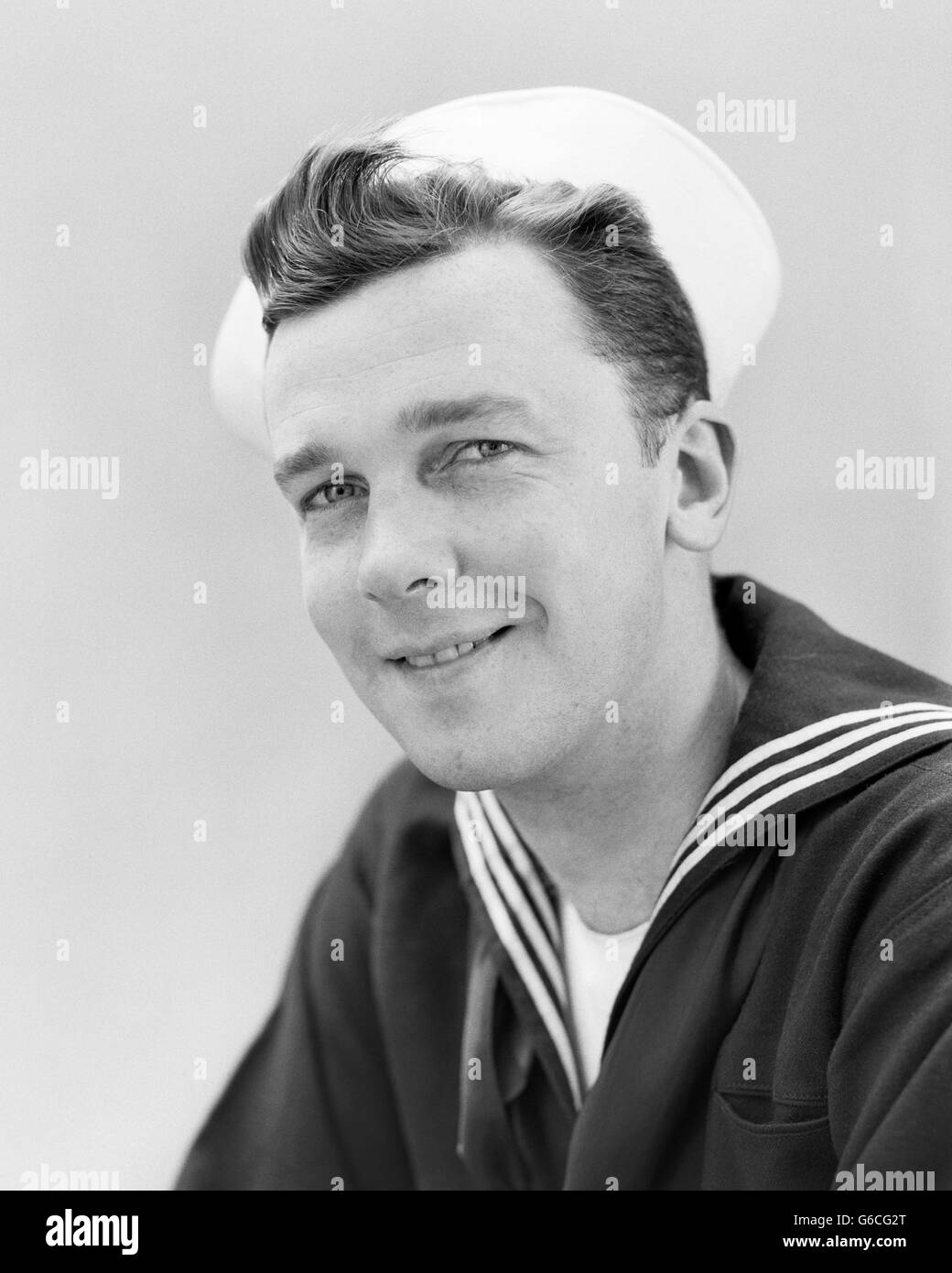 1940s SMILING PORTRAIT AMERICAN SAILOR WEARING NAVY UNIFORM LOOKING AT ...