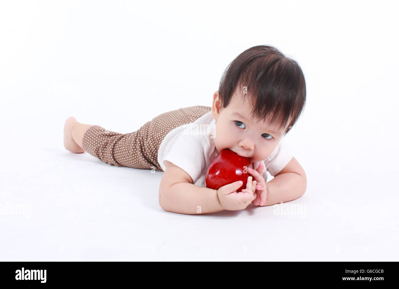 Cute baby with red apple (eating healthy food Stock Photo - Alamy