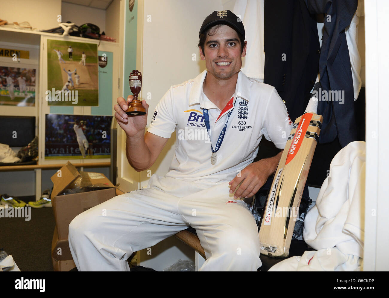 England captain Alastair Cook poses with the Urn in his dressing room ...