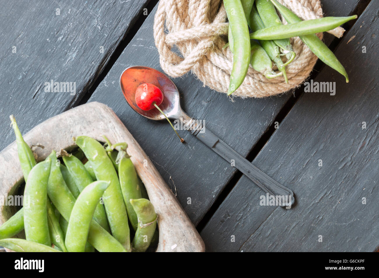 spoon with a cherry and green beans Stock Photo - Alamy