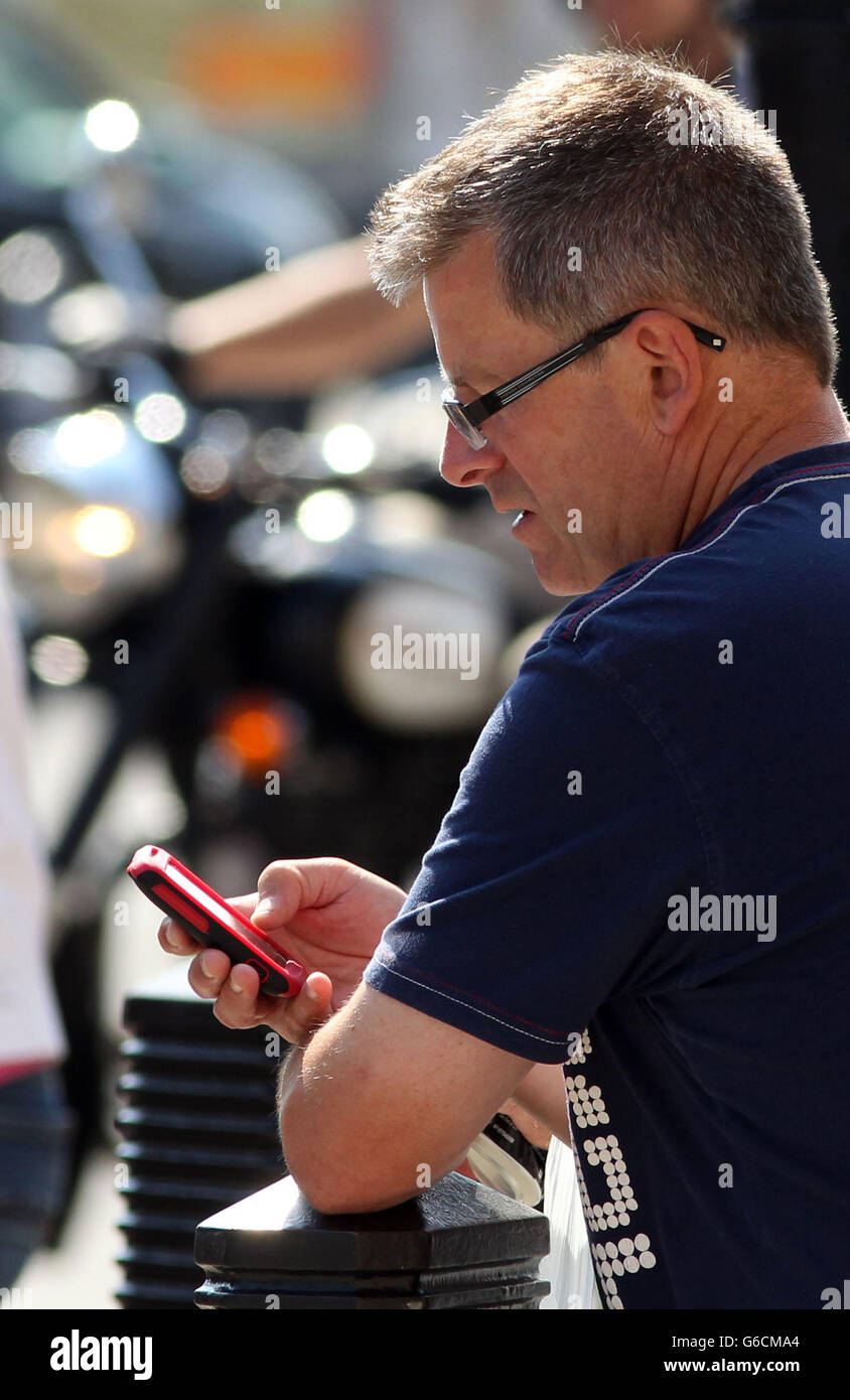 A member of the public uses their mobile phone in Central London Stock ...