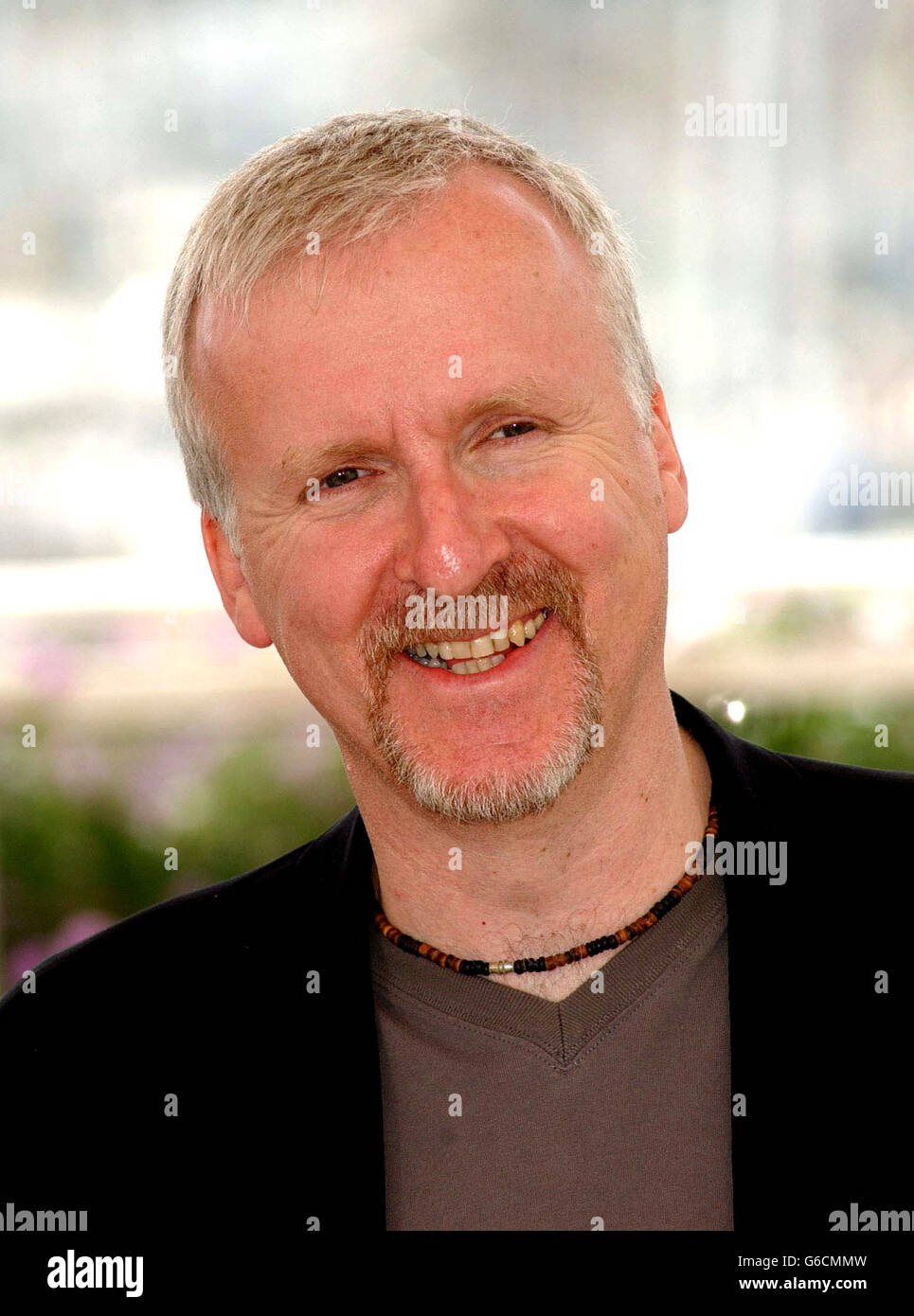 Celebrity director smiling bead necklace smiling head shoulders uig ...