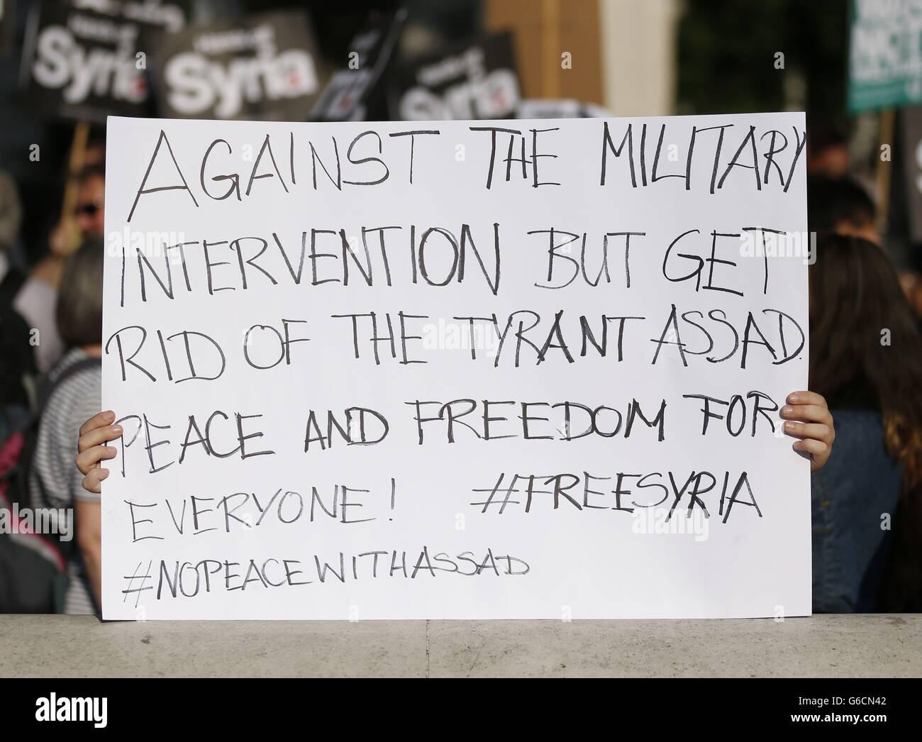 An activist holds a sign during an event organised by Stop the War ...