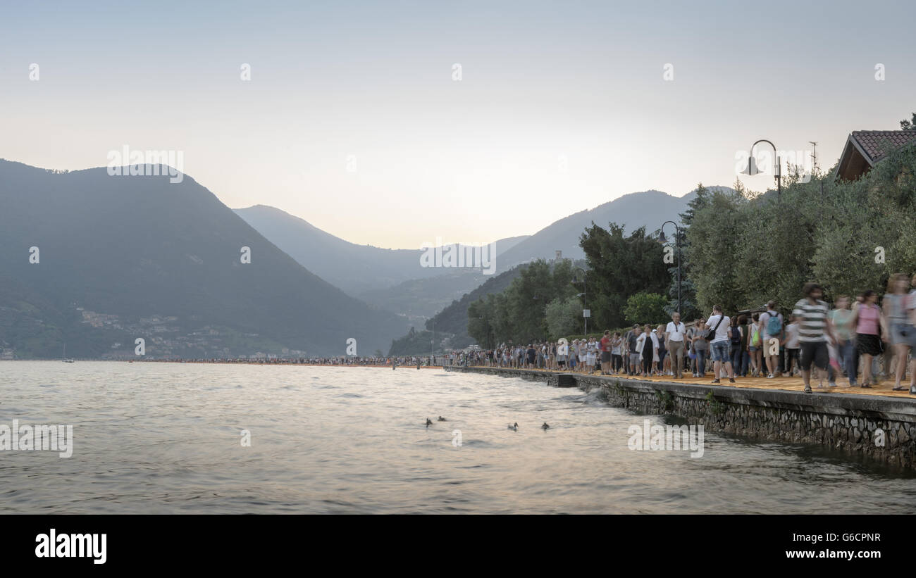 The Floating Piers Christo project. Visitors walking from Sulzano to ...