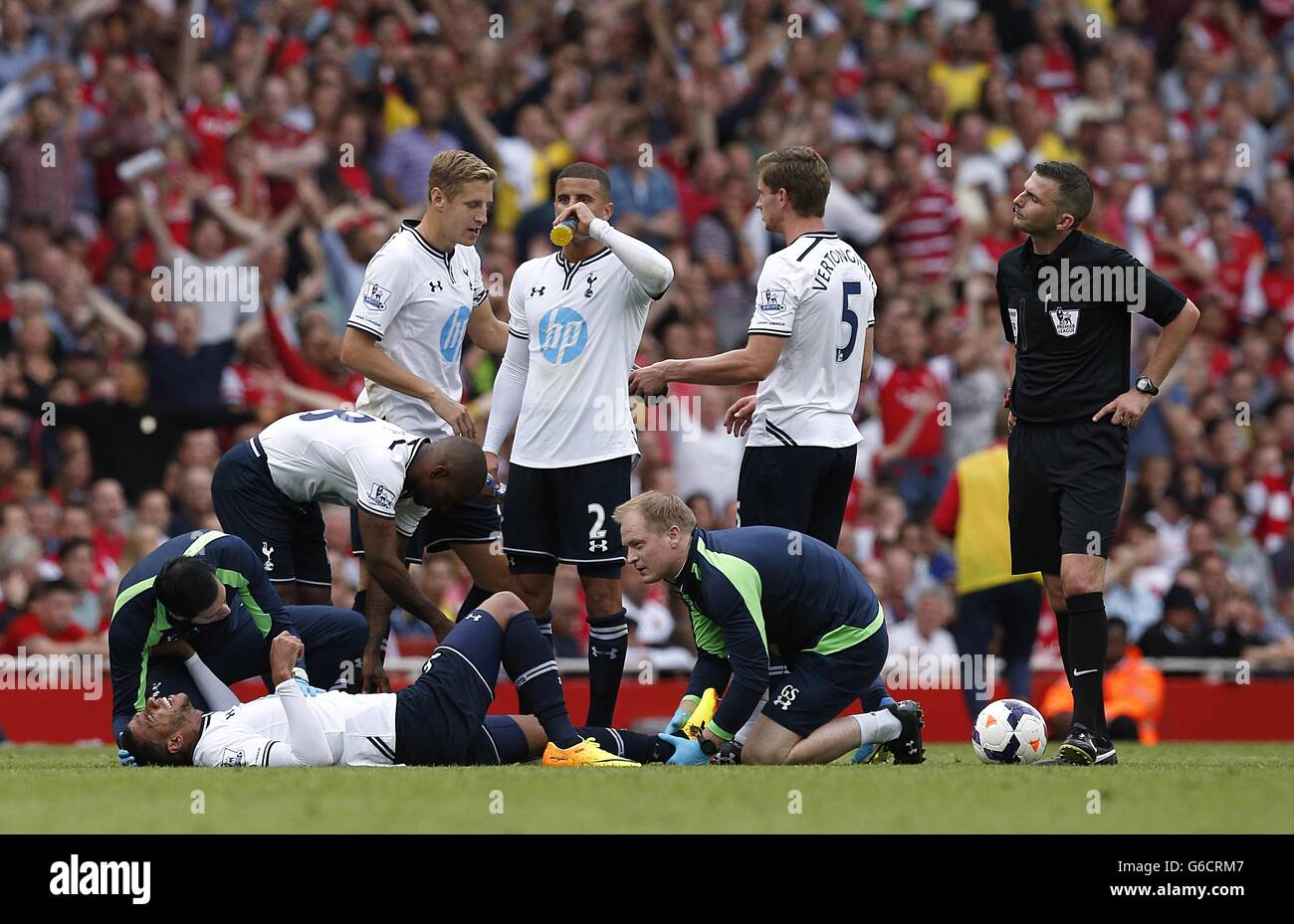 Tottenham Hotspur's Etienne Capoue receives treatment for an injury ...