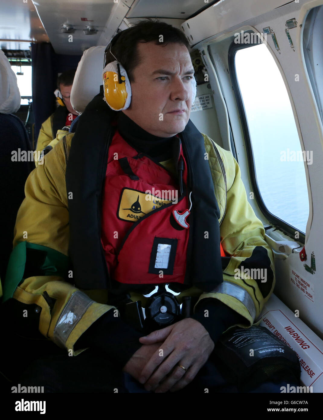 George Osborne looks out of the window of a Bristow A332L helicopter as ...