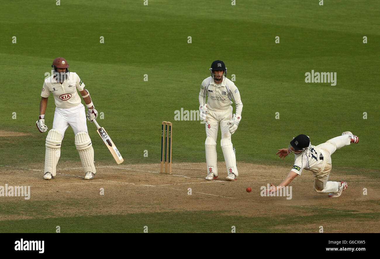 Surrey's Hashim Amla (left) watches as Middlesex's Sam Robson (right ...