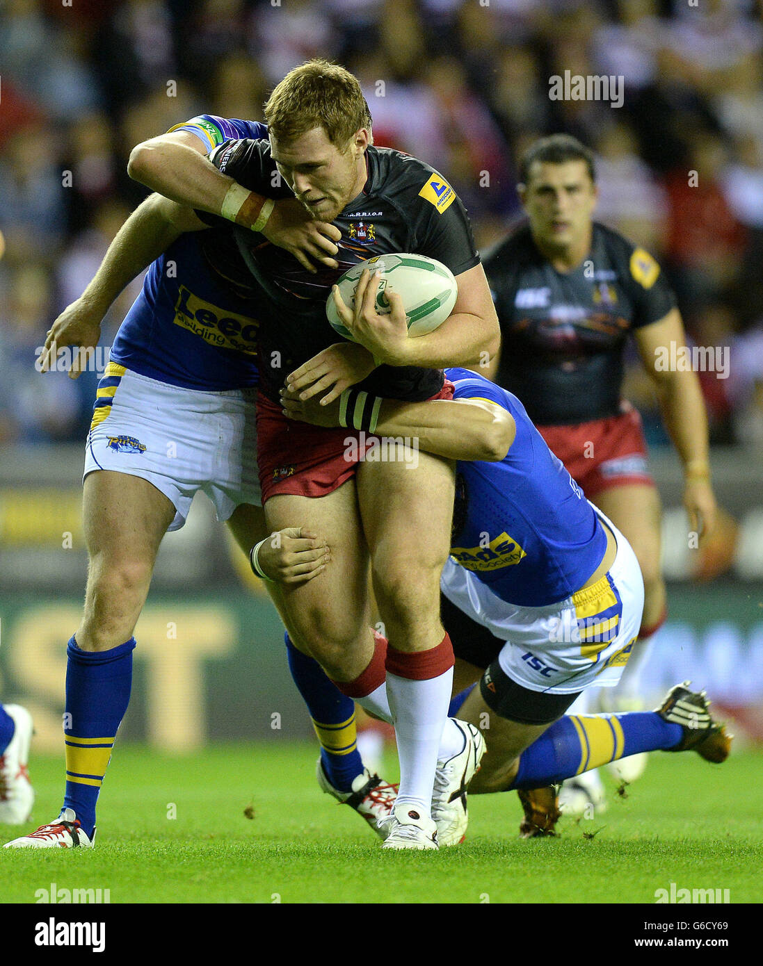 Wigan Warriors Iain Thornley is tackled by Leeds Rhinos Ian Kirke ...