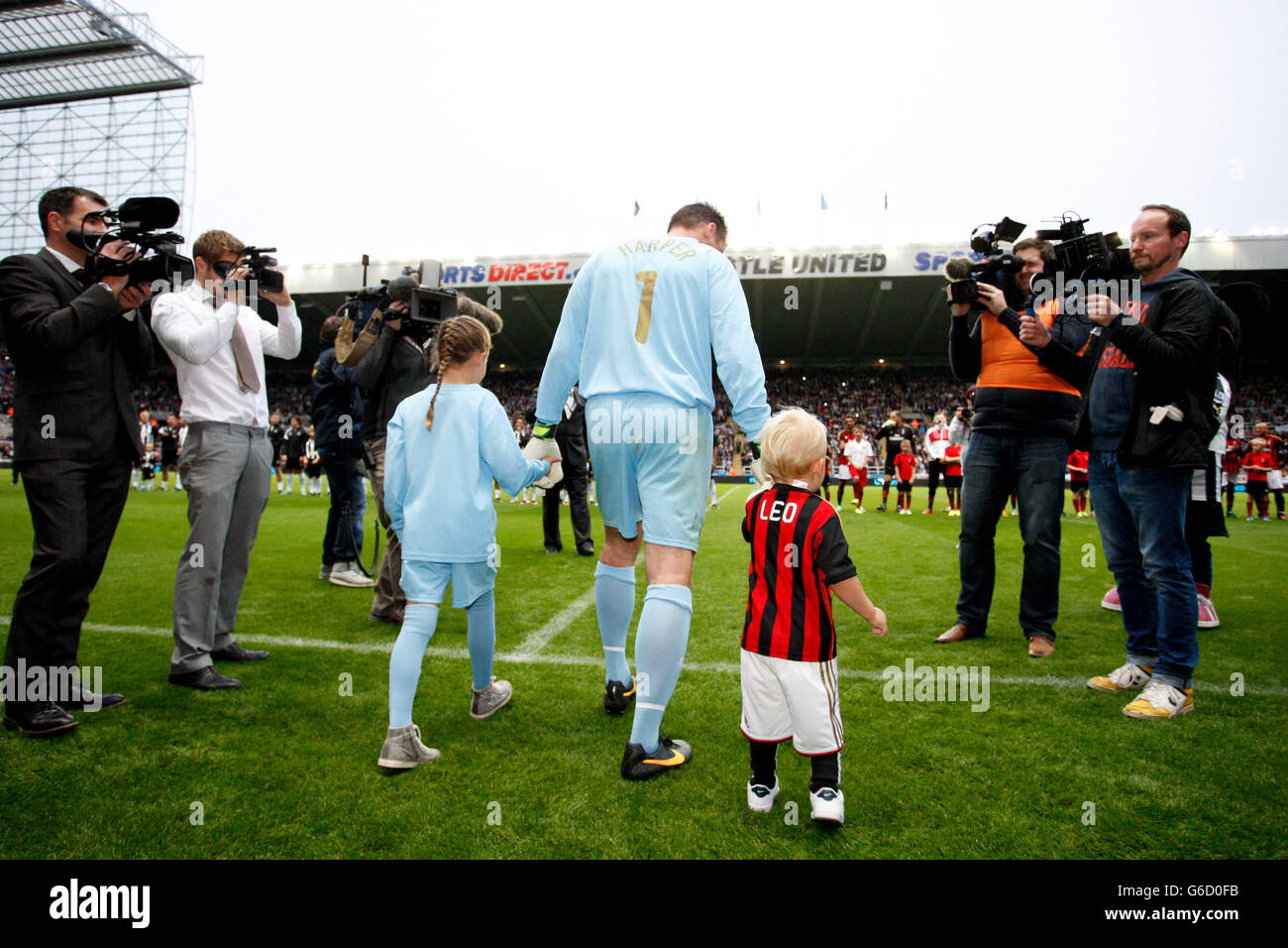 Newcastle United's Steve Harper walks onto the pitch with his children ...