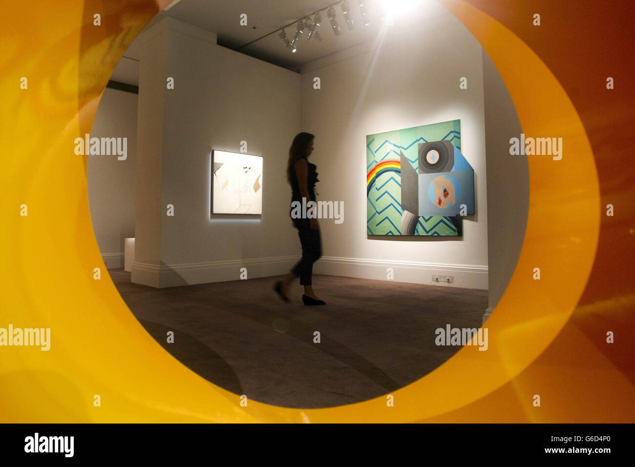 A Sotheby's employee seen through a sculpture called 'Untitled (Circle ...