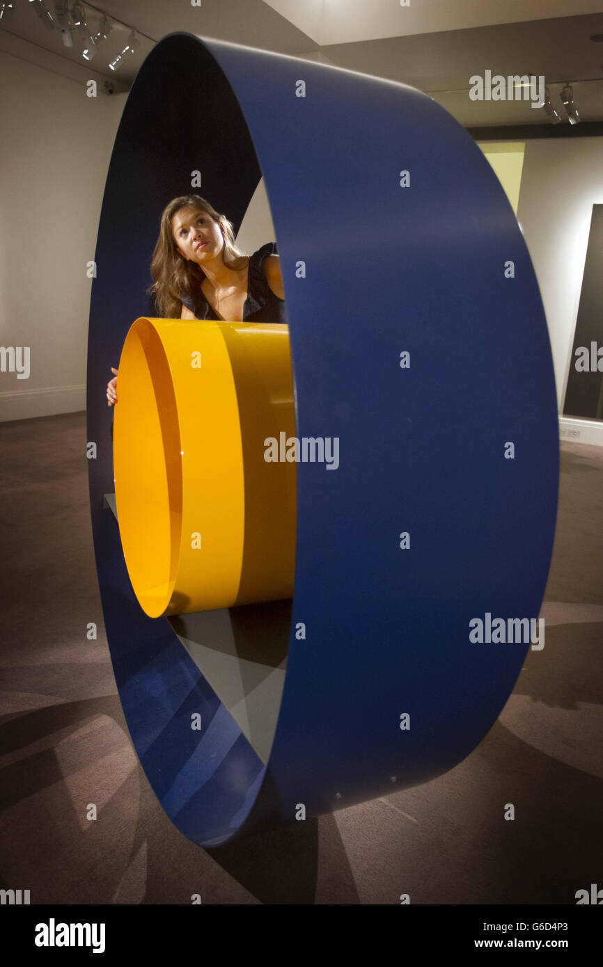 A Sotheby's employee is seen through a sculpture called 'Untitled ...