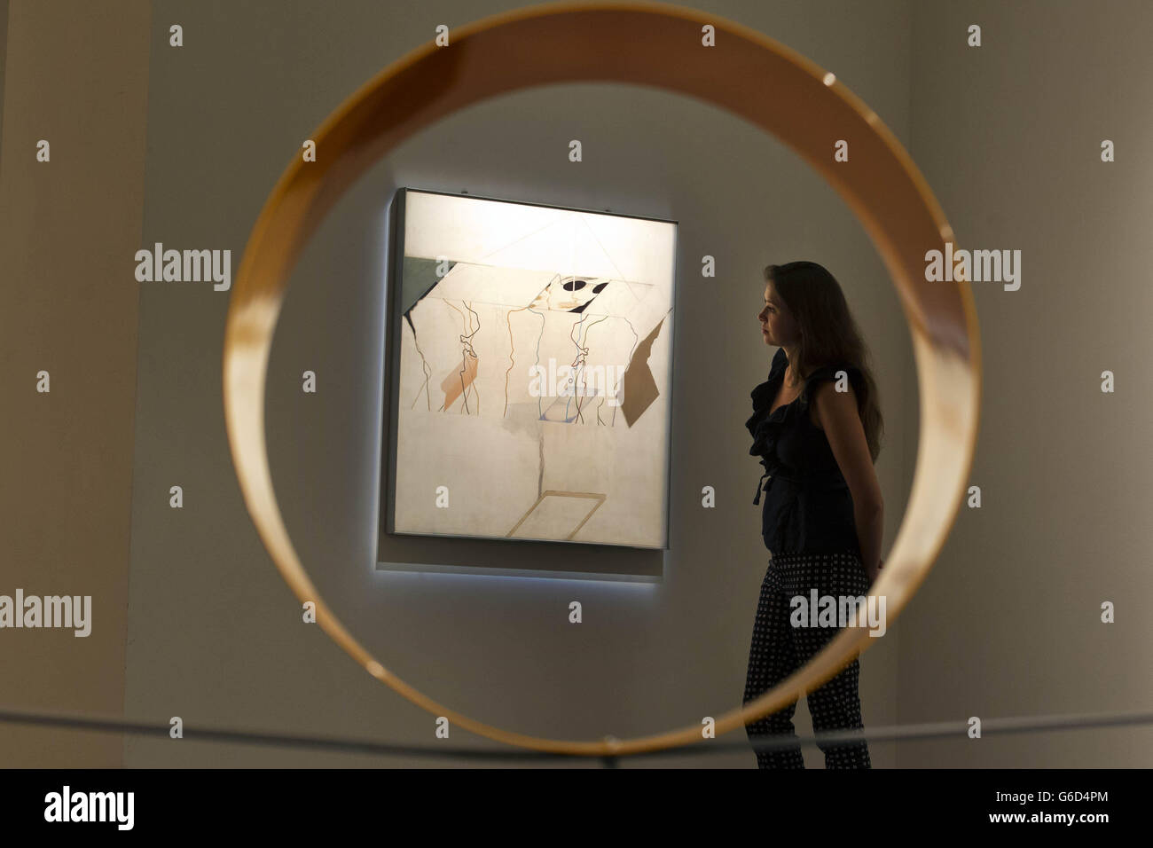 A Sotheby's employee seen through a sculpture called 'Untitled (Circle ...