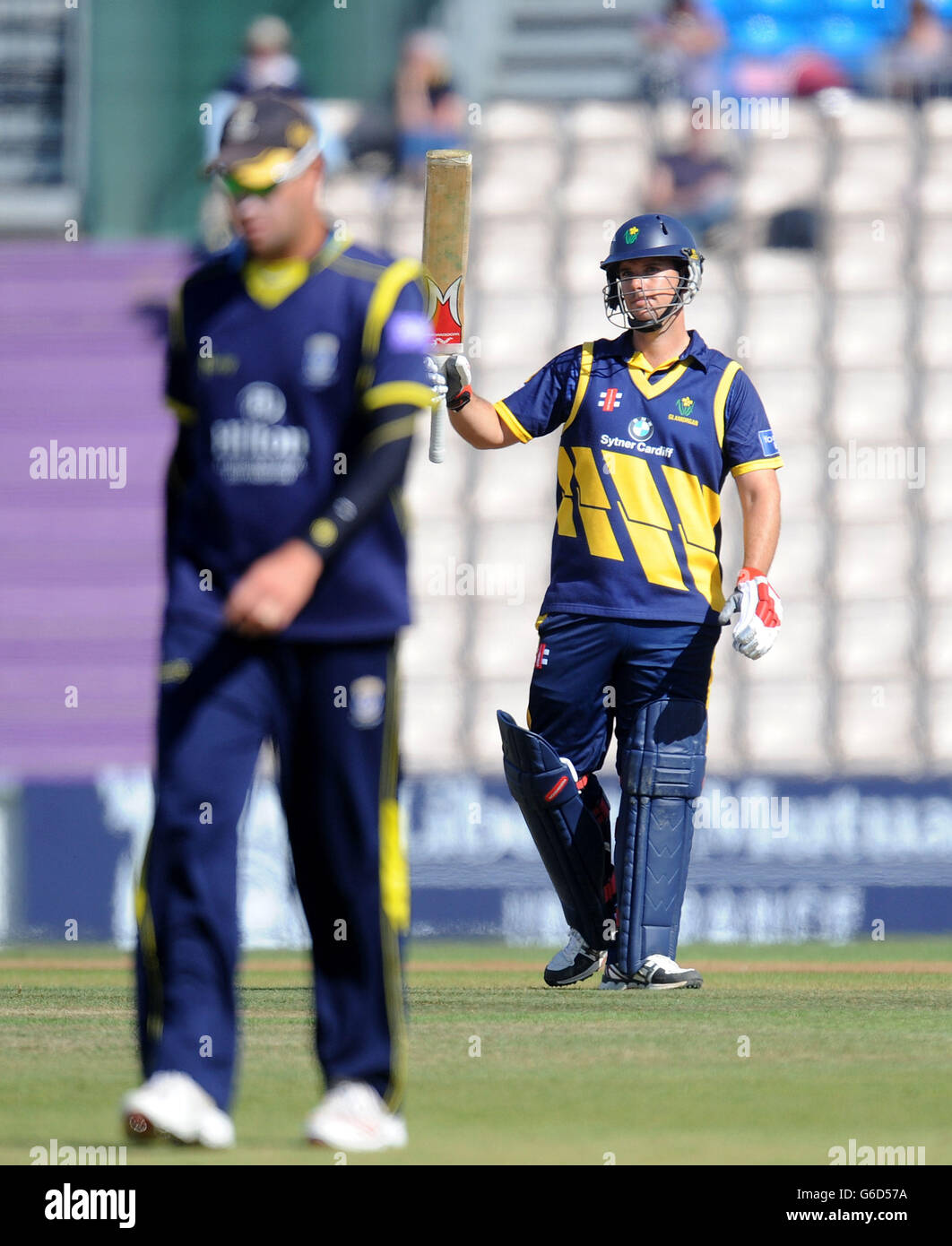 Glamorgan's Jim Allenby (right) raises his bat to acknowledge his half ...