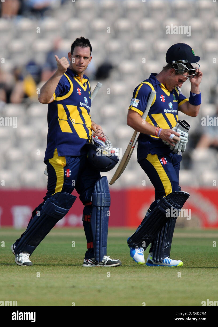 Glamorgan's Jim Allenby (left) gives a thumbs up as he leaves the field ...