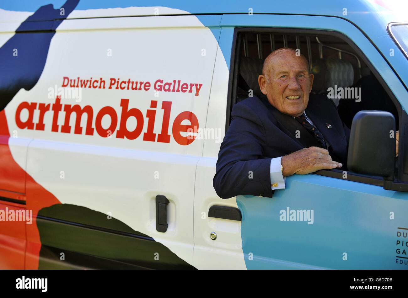 Former Formula One racing driver, Sir Stirling Moss behind the wheel of ...