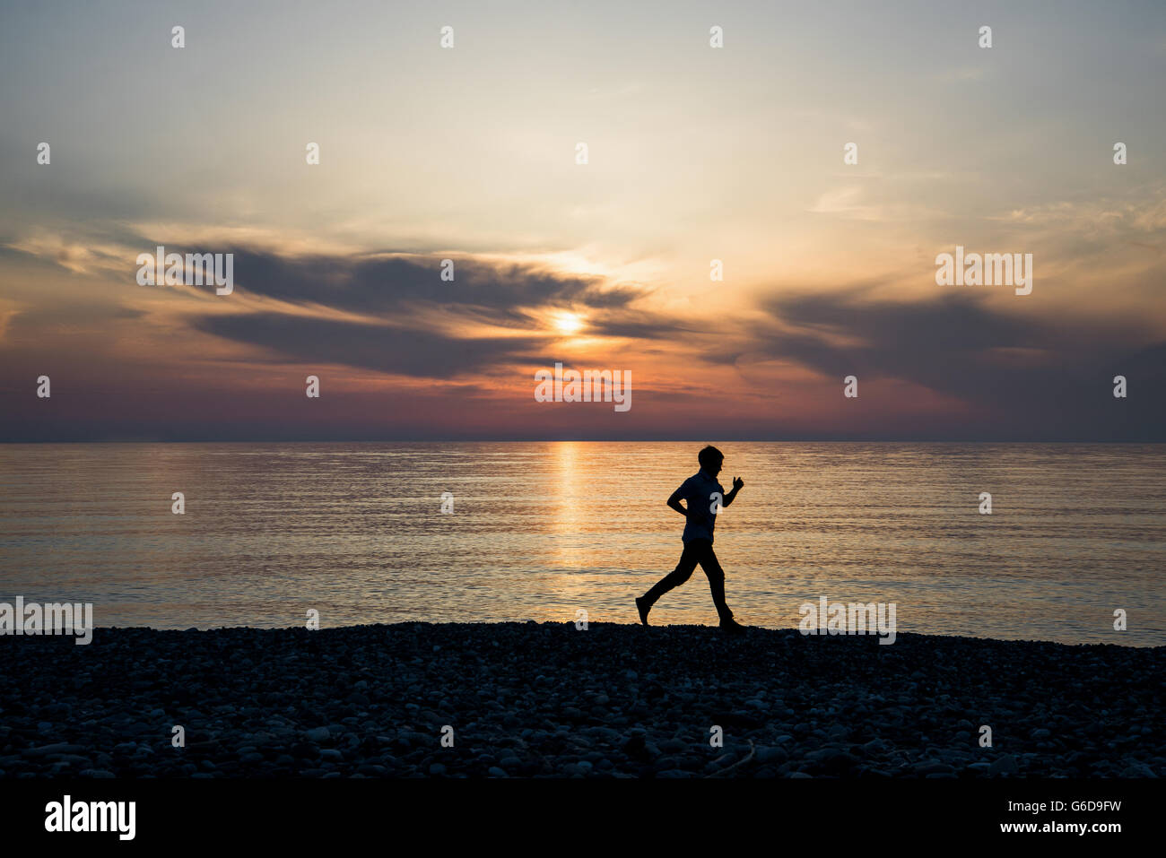 Male runner silhouette on the beach Stock Photo - Alamy