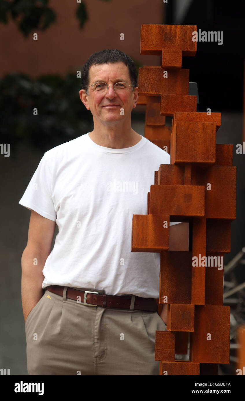 Sculptor Antony Gormley stands next to one of his artworks at his North ...