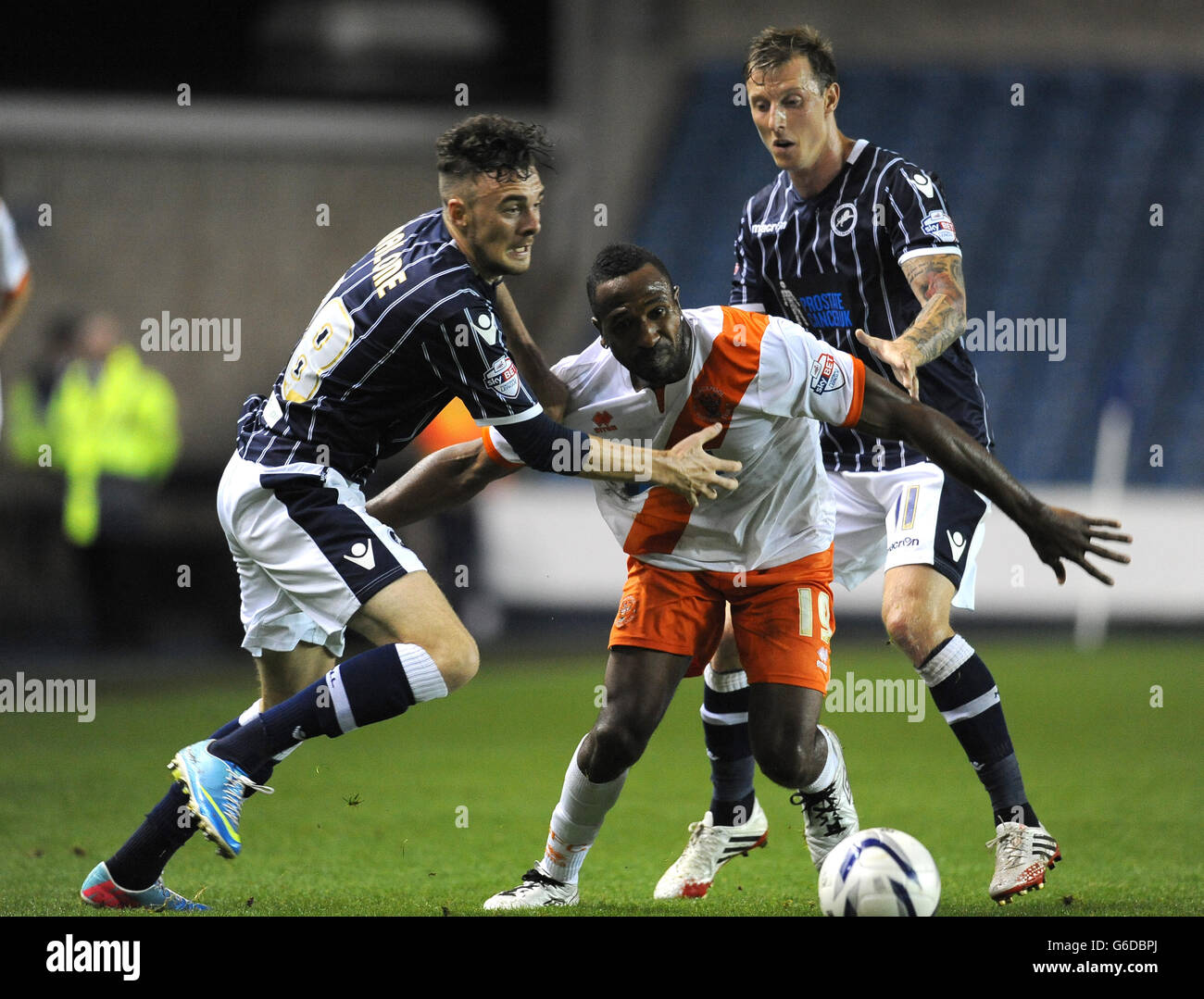 Millwall's Scott Malone (left) and Martyn Woolford (right) challenge ...