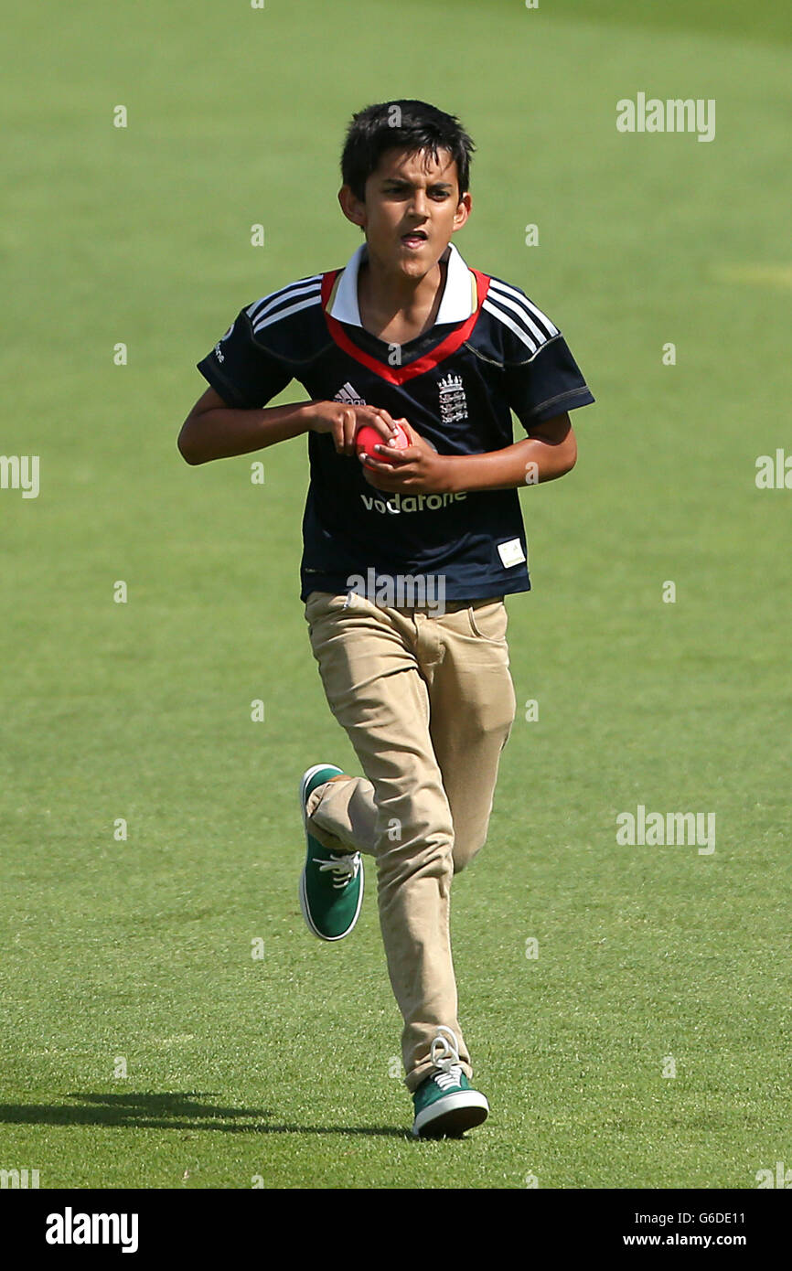 A cricket fan enjoys playing on the pitch during the break Stock Photo ...