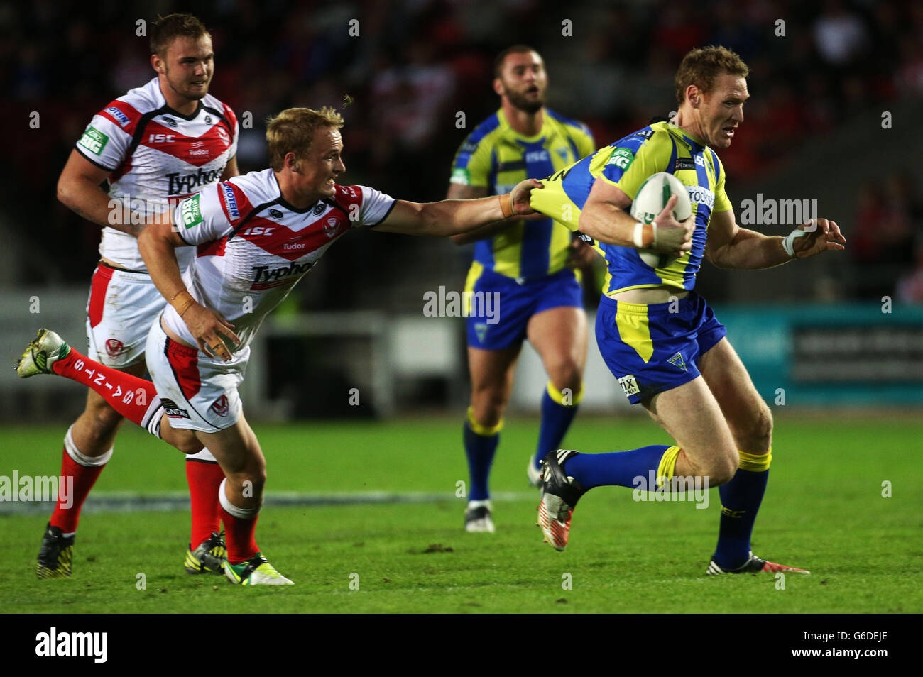 Warrington Wolves Joel Monaghan is caught by St Helen's Stuart Howath ...