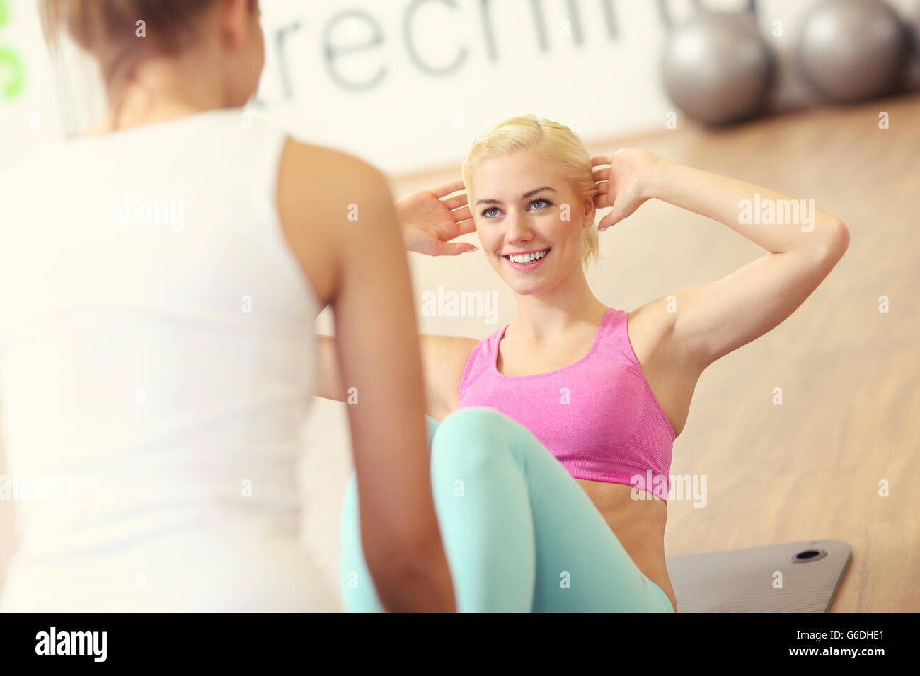 Picture of fit woman doing sit ups in gym Stock Photo - Alamy
