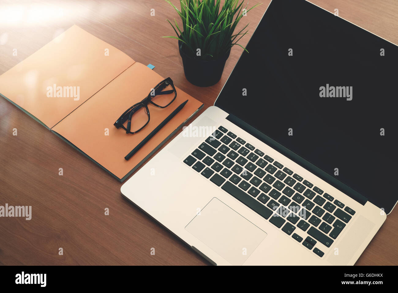 top view of new modern computer laptop with blank screen and blank book ...