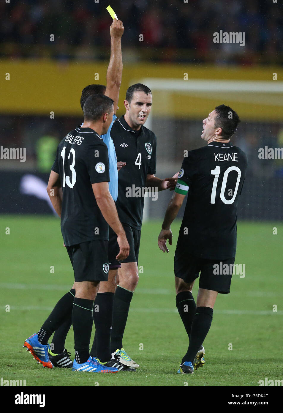 Republic of Ireland's Robbie Keane is booked by referee Olegario ...