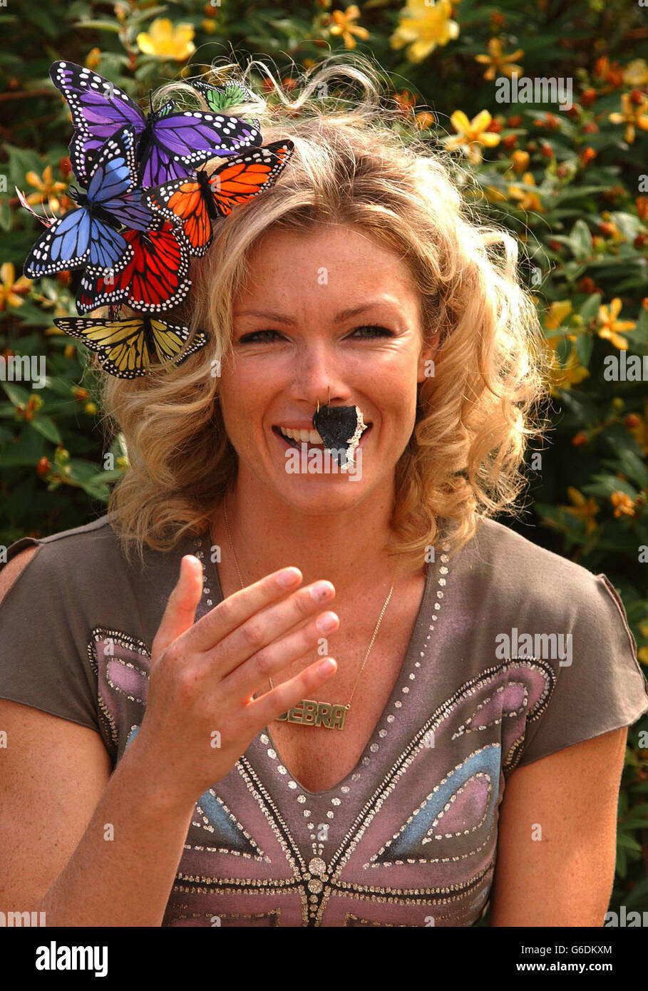 Nell McAndrew in London's Hyde Park with a butterfly on her nose to ...